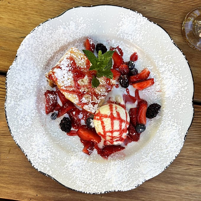 Berry-adorned dessert that doesn't just end the meal—it celebrates it. That powdered sugar snowfall makes even the strictest diets surrender.