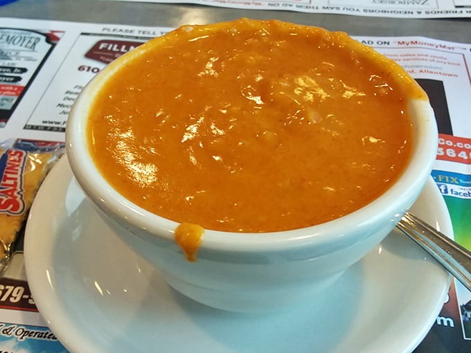 This isn't just soup – it's liquid comfort in a bowl. The rich orange hue promises flavor depths that chain restaurants can only dream about.