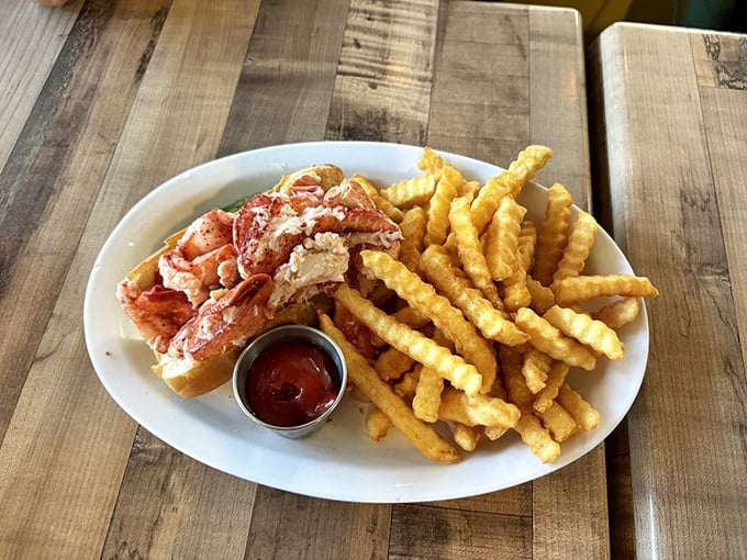 The lobster roll of your dreams – sweet, succulent meat piled high on a toasted split-top bun with golden fries standing guard. No passport required.