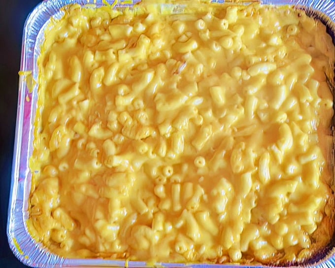 Mac and cheese so gloriously yellow it could guide ships to shore. This isn't just comfort food—it's a warm hug on a plate.