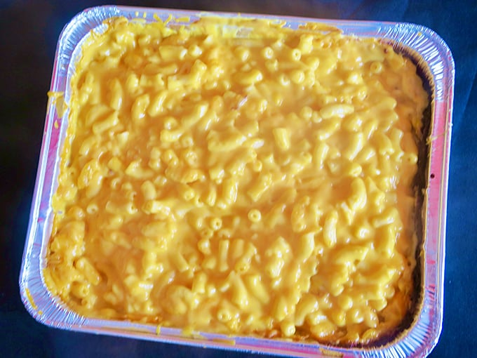 Mac and cheese that doesn't know the meaning of al dente—this is pure, molten comfort in a foil pan, the way grandma intended.