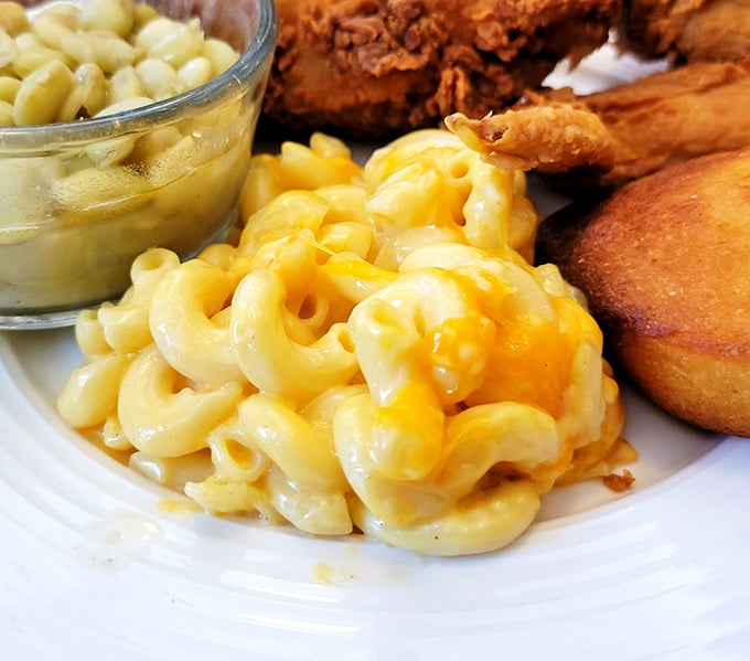 Mac and cheese that doesn't just sit on the plate – it poses, showing off that perfect cheese-pull potential with every forkful.