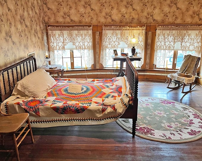 A bedroom that whispers tales of simpler times – when a colorful quilt and rocking chair constituted the ultimate luxury streaming package.