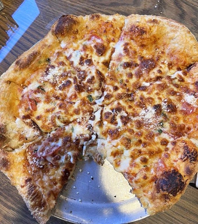 This hand-tossed pizza has the perfect cheese-to-crust ratio—the kind that makes you wonder if the chef has a Ph.D. in geometry.