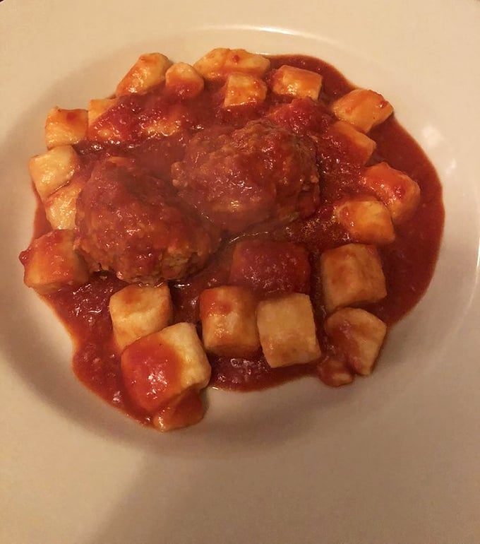 These meatballs don't just sit in sauce – they reign over it like tiny, savory monarchs on a tomato throne.