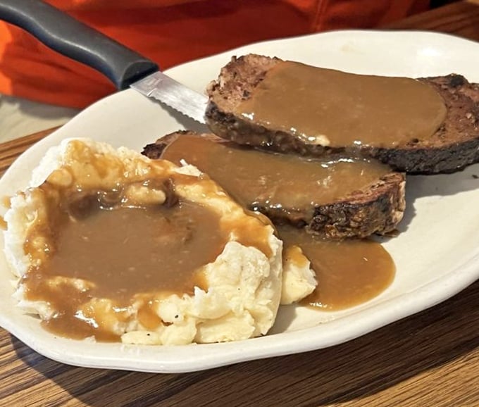 Meatloaf and mashed potatoes swimming in gravy – comfort food that hugs your soul before it fills your stomach.
