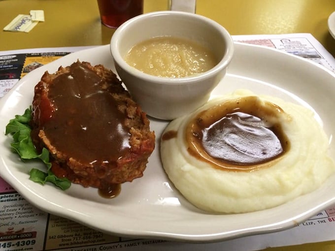 Meatloaf and mashed potatoes with gravy pooling just so—the kind of plate that makes you want to call your mother and apologize.