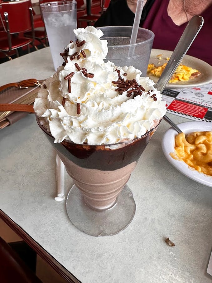 This isn't just a milkshake – it's a tower of chocolate bliss topped with enough whipped cream to make your inner child giggle with delight.
