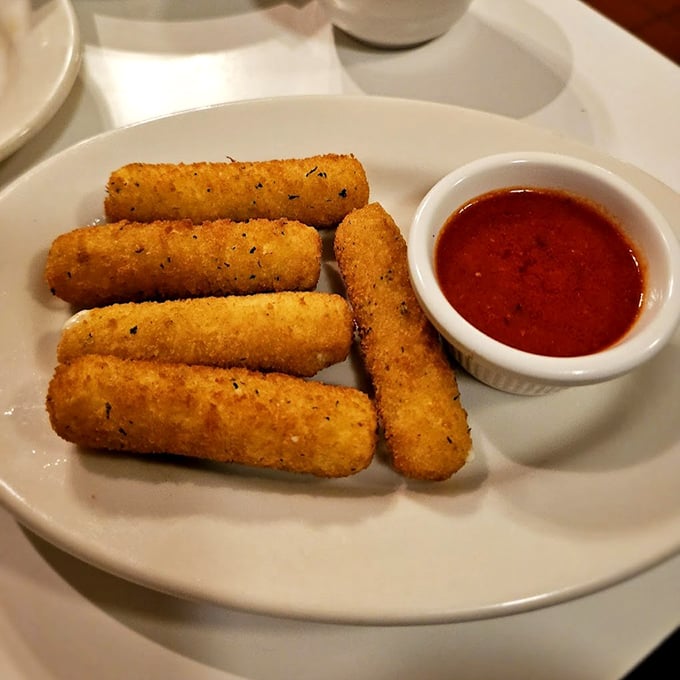 Golden-brown mozzarella sticks that shatter with that first bite, revealing the stretchy cheese inside – nature's perfect food.