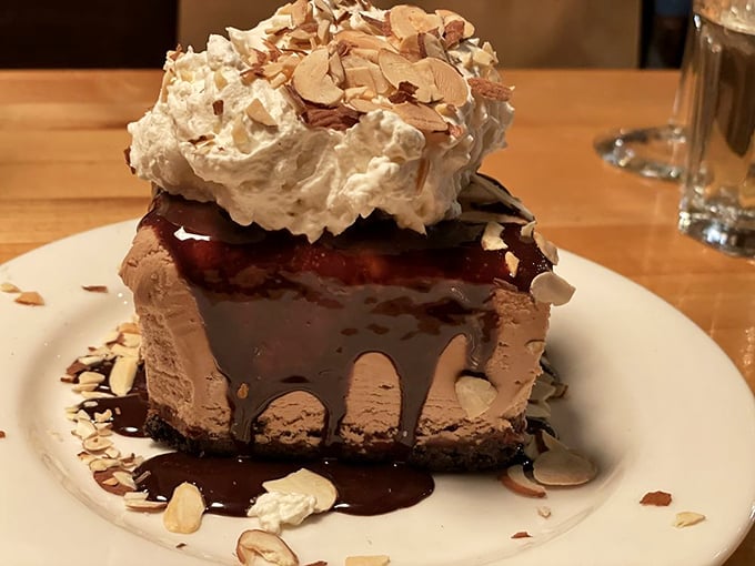 This isn't just dessert—it's architecture with whipped cream. The chocolate, the almonds, the drizzle—it's the Taj Mahal of cheesecake.