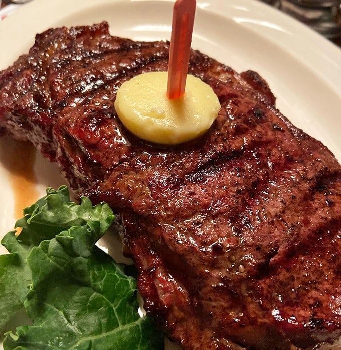 This New York Strip isn't just cooked – it's been transformed into a carnivore's dream, complete with that signature oak-fired char that whispers sweet nothings to your taste buds.
