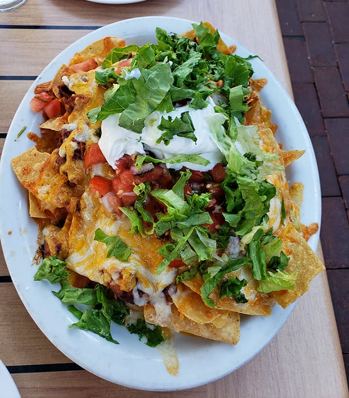 These loaded nachos aren't just a starter—they're a commitment to happiness, layered with cheese, fresh veggies, and enough toppings to require a strategy.