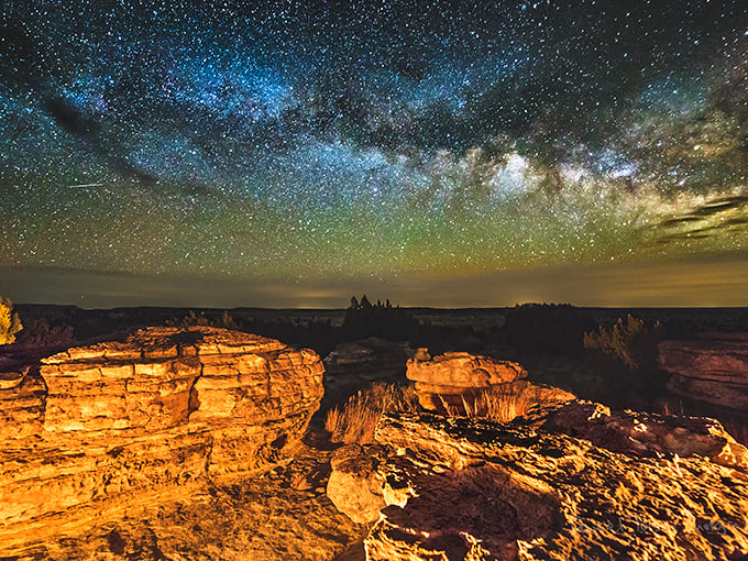 The Milky Way explodes across Black Mesa's night sky in a display that makes city lights seem embarrassingly inadequate.