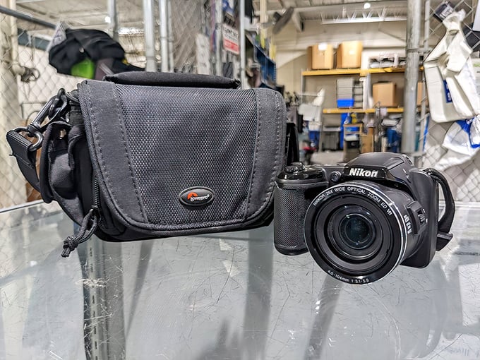 A pristine Nikon Coolpix camera sits ready for its close-up – the kind of unexpected jackpot that keeps thrift enthusiasts coming back for "just one more look."