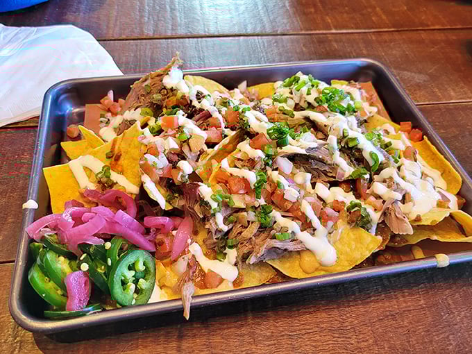 Nachos reimagined by smoke wizards – a mountain of chips, meat, and toppings that makes sharing both necessary and nearly impossible.