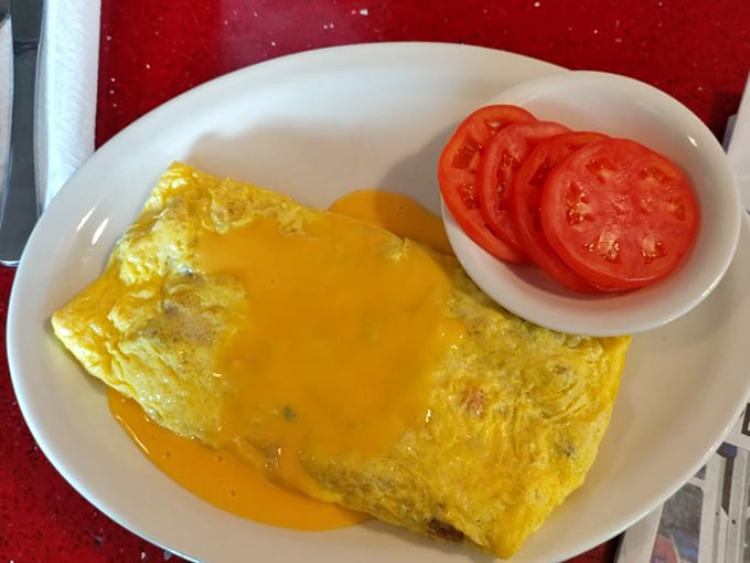This omelet doesn't just contain cheese—it celebrates it. With fresh tomatoes on the side, it's breakfast perfection that requires no translation in any language.