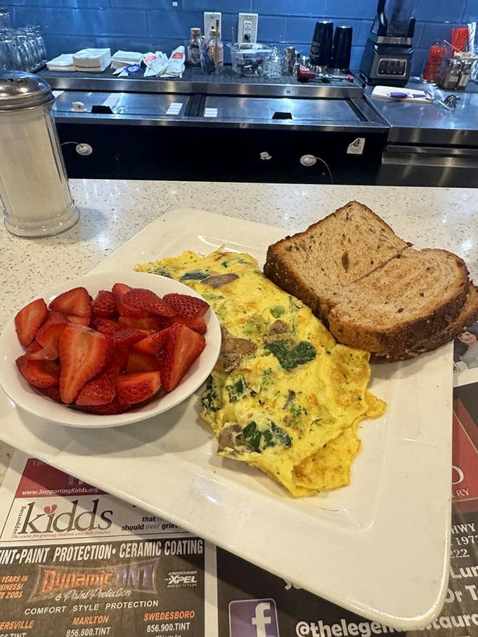 This isn't just an omelet—it's a morning masterpiece with fresh strawberries playing the perfect supporting role. Breakfast of champions, indeed.