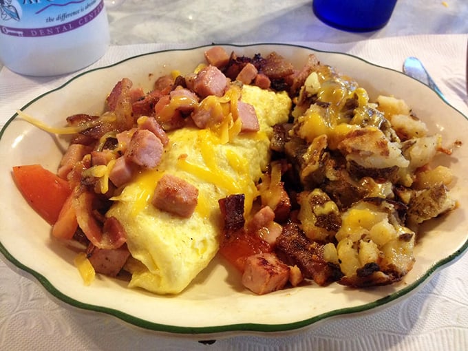 An omelet that doesn't just feed you—it embraces you. The ham and cheese ratio here deserves its own mathematical theorem.