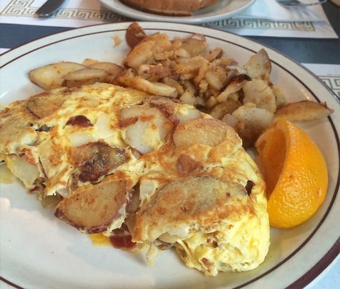This omelet doesn't need fancy European cheese or truffle oil—just perfectly cooked eggs embracing potatoes in a breakfast hug that feels like home.