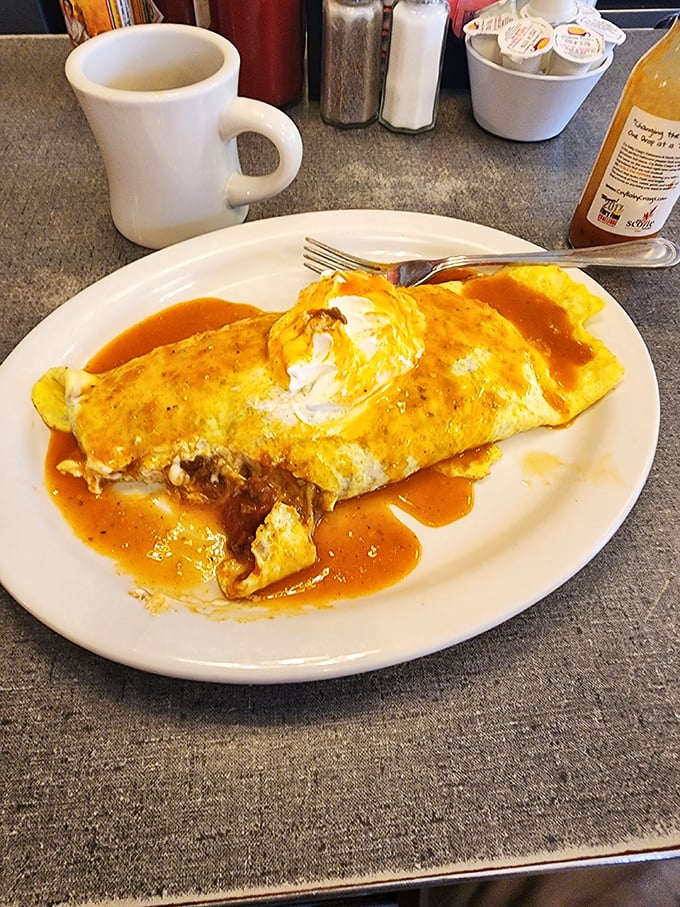 This omelet didn't just break free from its shell—it achieved its full potential, swimming gloriously in what appears to be homemade chili sauce.