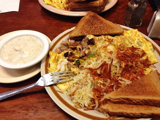 An omelet that requires both commitment and stretchy pants, served with crispy hashbrowns and toast for the complete morning experience.