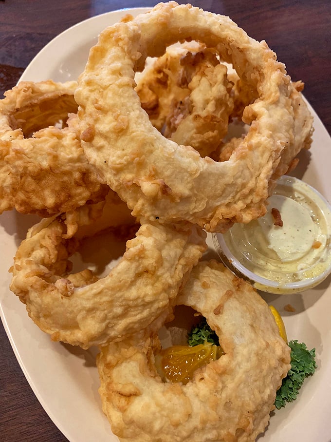 Golden-fried onion rings that crunch like autumn leaves—except these leaves make you say "mmm" instead of "time to rake."