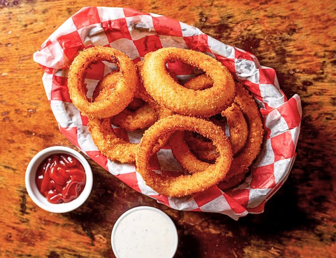 Golden-brown onion rings that shatter with that perfect crunch – the supporting actors that sometimes steal the show from the burger headliners.