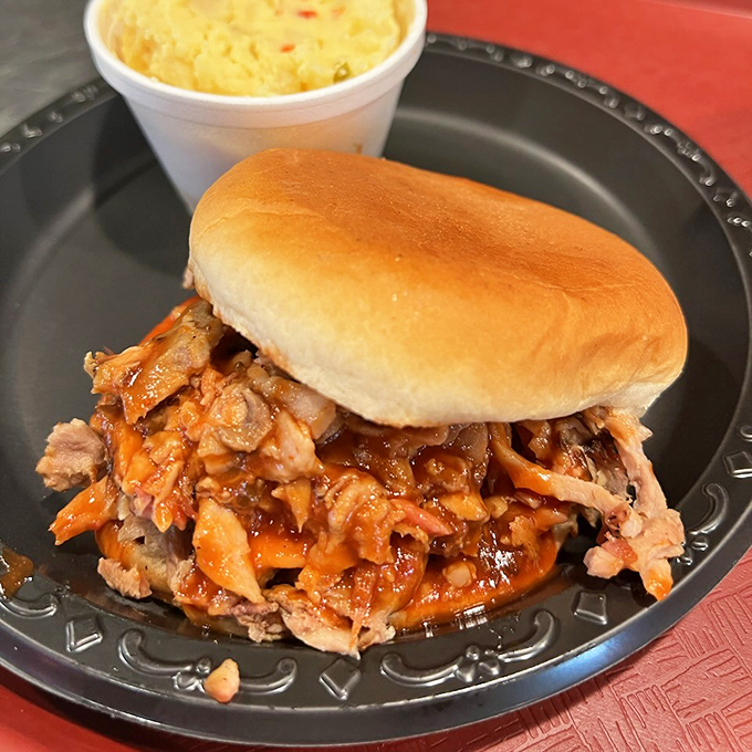 This isn't just a sandwich; it's a monument to pork perfection—tender, smoky meat with just enough sauce to complement, not drown, those hickory-kissed flavors. 