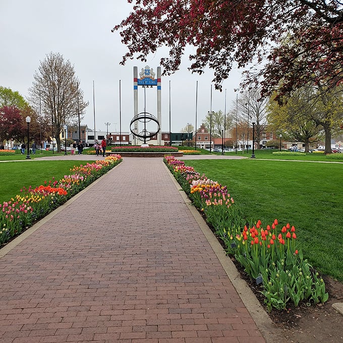 Tulips line the park's pathways like nature's red carpet, leading visitors to Pella's iconic central monument.