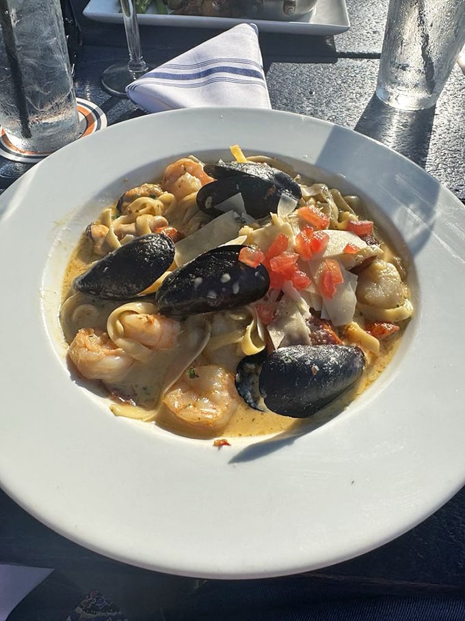 Seafood pasta that looks like Neptune himself catered your meal—mussels, shrimp, and pasta dancing in a creamy sea of deliciousness.