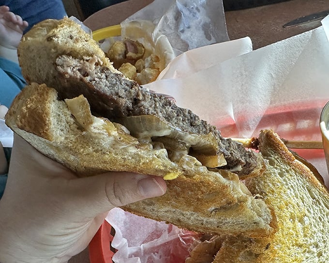 The patty melt—that perfect marriage of burger and grilled cheese—executed with the kind of precision that makes you wonder if Einstein had a secret career as a short-order cook.