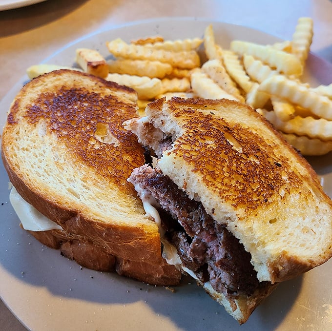 Not just a patty melt—a work of art. Golden-grilled bread embracing melted cheese and beef in a sandwich that demands to be remembered.