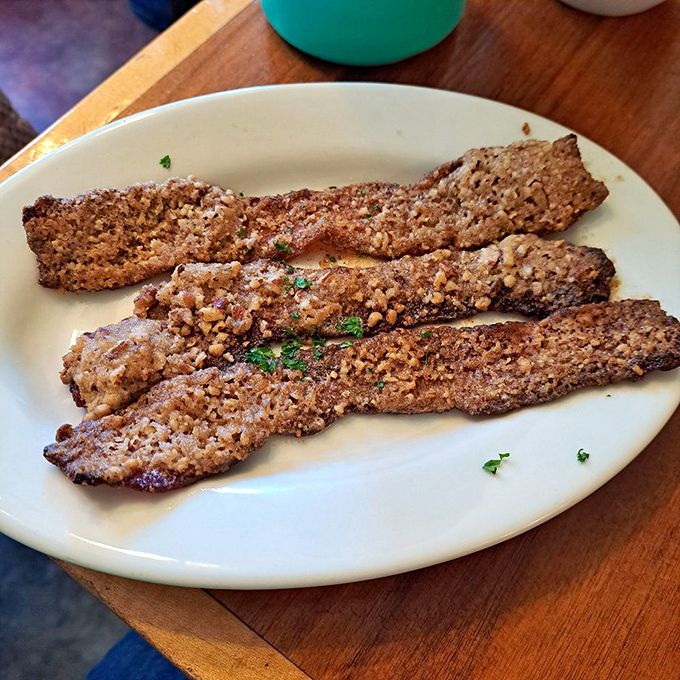 Pecan-crusted bacon that makes ordinary strips seem like a tragic waste of potential. Whoever thought of this deserves a Nobel Prize in breakfast innovation.