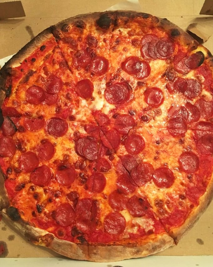 Pepperoni that curls into little flavor cups, collecting pools of spicy oil. This isn't just pizza – it's edible architecture.