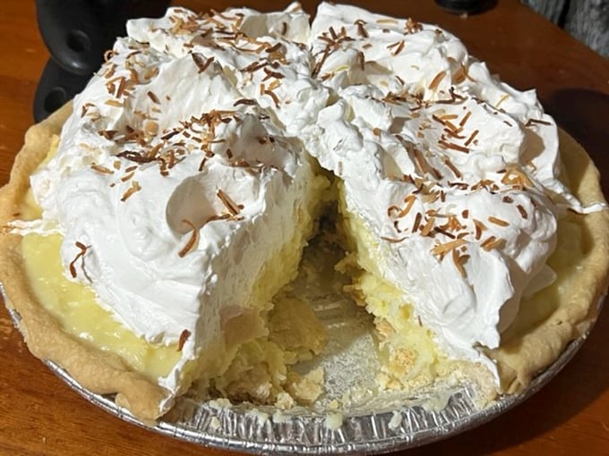 This coconut cream pie doesn't just have a mile-high meringue – it has its own zip code and possibly its own weather system. 