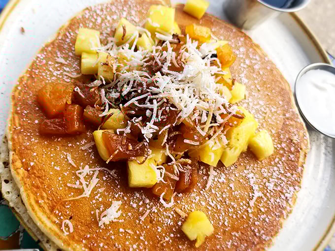 Golden pineapple pancakes that taste like vacation—topped with coconut shavings that make your taste buds feel like they're on a tropical getaway.