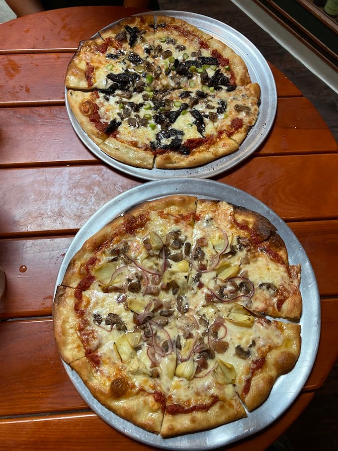 These aren't just pizzas—they're edible works of art with crusts that crackle and toppings that tell stories. The bottom one is whispering sweet nothings about caramelized onions.