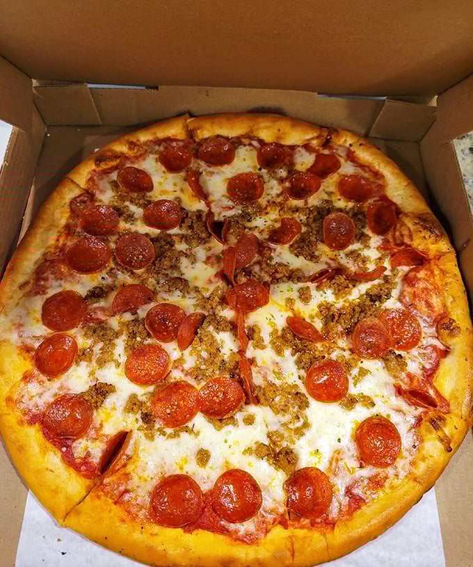 Pizza perfection in a box: that golden crust, melted cheese, and the pepperoni-sausage combo that makes Monday meetings bearable.
