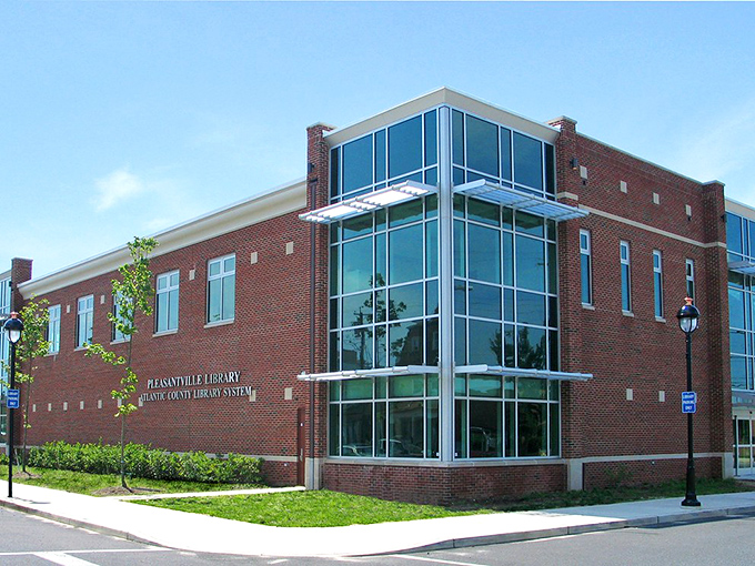 The modern Pleasantville Library proves small towns can have big resources – its glass corner entrance inviting curious minds of all ages inside.