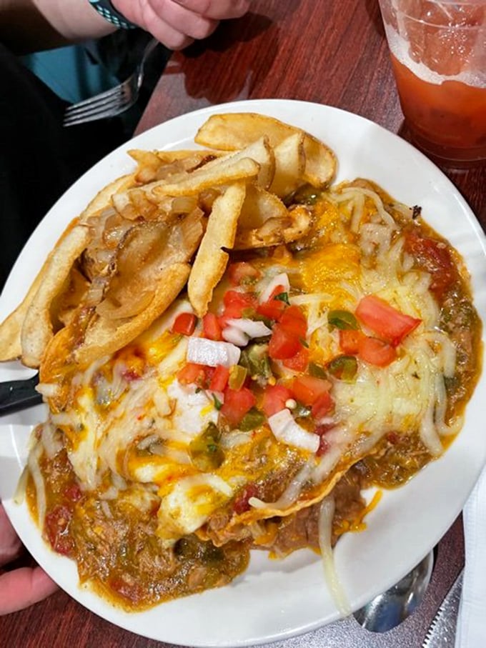 The pork chili verde – a masterpiece of melted cheese, savory sauce, and fresh pico de gallo that makes you wonder why you'd ever eat breakfast anywhere else.
