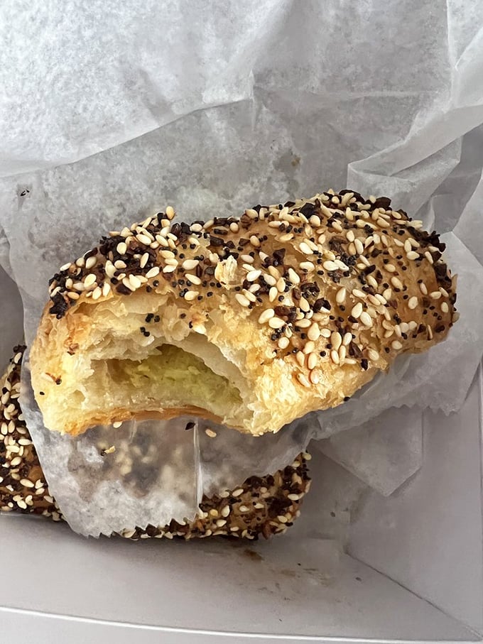 The potato borekas reveal their flaky, golden souls – these sesame-flecked pastries are what croissants dream of becoming in their next life.