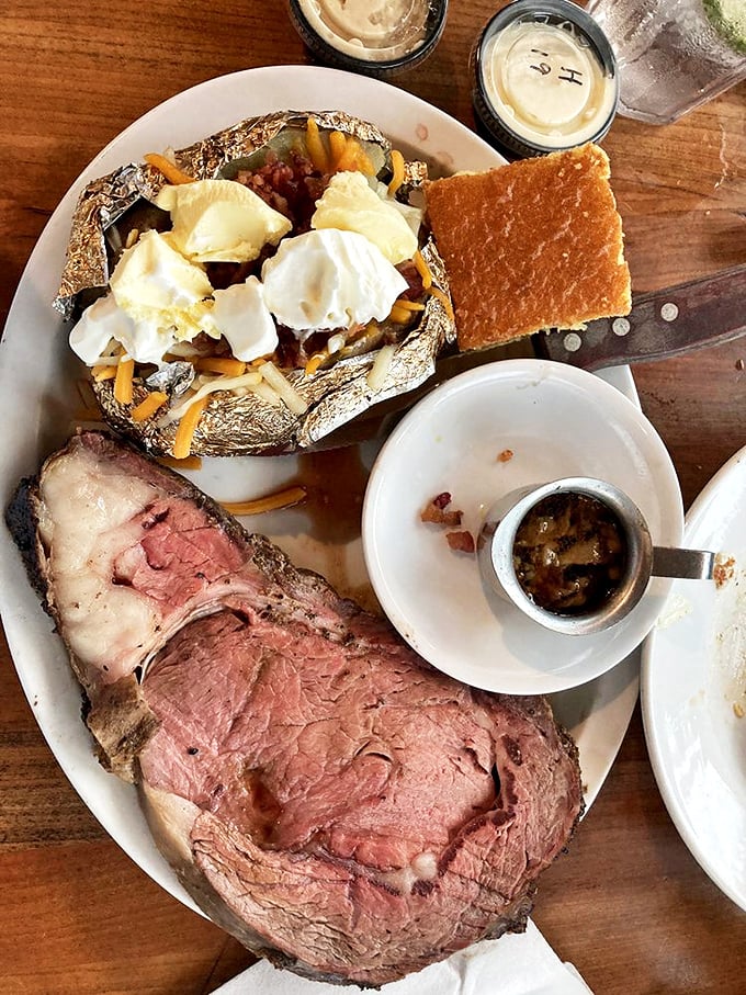Prime rib with the perfect pink center alongside a loaded baked potato—proof that sometimes the classics are classics for good reason.