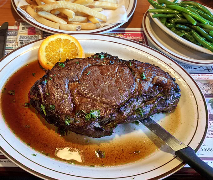 This isn't just prime rib—it's a masterclass in carnivorous pleasure, complete with an orange slice winking at you from the plate.