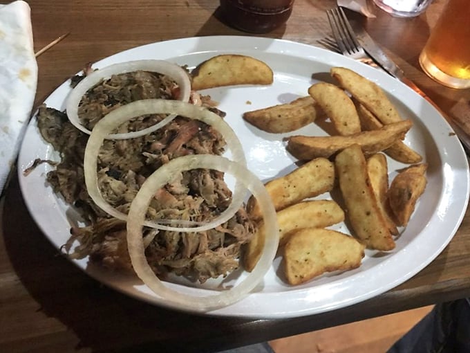 Pulled pork with rings of raw onion—nature's palate cleanser that ensures you taste every magnificent morsel of that slow-smoked goodness.