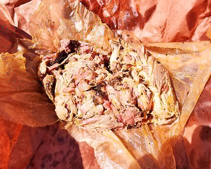 Pulled pork so tender it surrenders completely, nestled in butcher paper like the precious treasure it is. No fork necessary—just willing fingers.