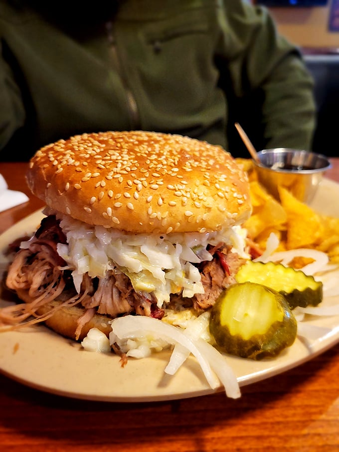 This pulled pork sandwich isn't just a meal – it's an architectural marvel of smoke-kissed meat, tangy slaw, and golden bun.