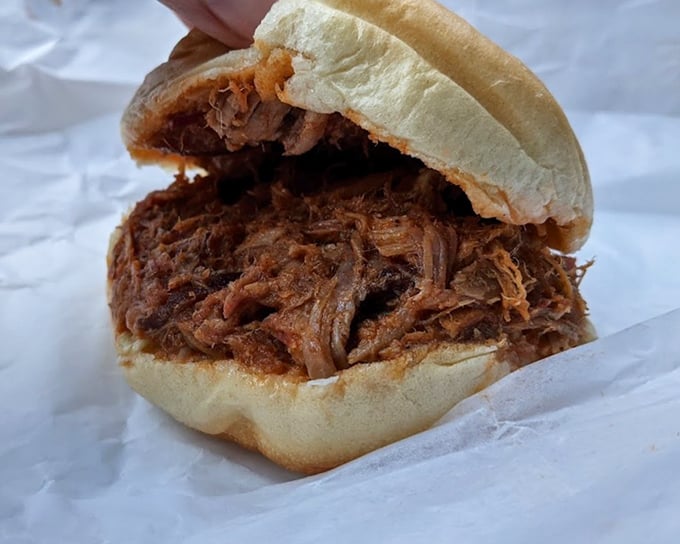 This isn't just a sandwich; it's a masterclass in pulled pork – tender, smoky meat piled high on a bun that somehow maintains its structural integrity.