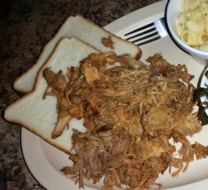 This pulled pork doesn't need fancy presentation—just a simple slice of bread to catch the juices you'd otherwise be tempted to drink.