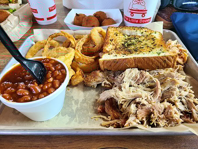 This isn't just a meal, it's edible architecture – pulled pork, baked beans, garlic toast, and onion rings building a monument to Southern comfort.