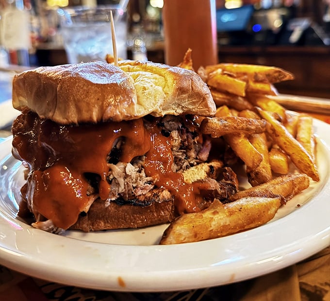 This isn't just a sandwich—it's an architectural marvel of pulled pork, sauce, and bread that requires both hands and zero shame.
